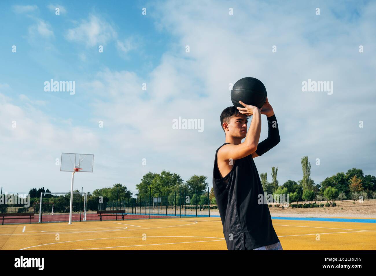 Young man playing on basketball court outdoor Stock Photo - Alamy