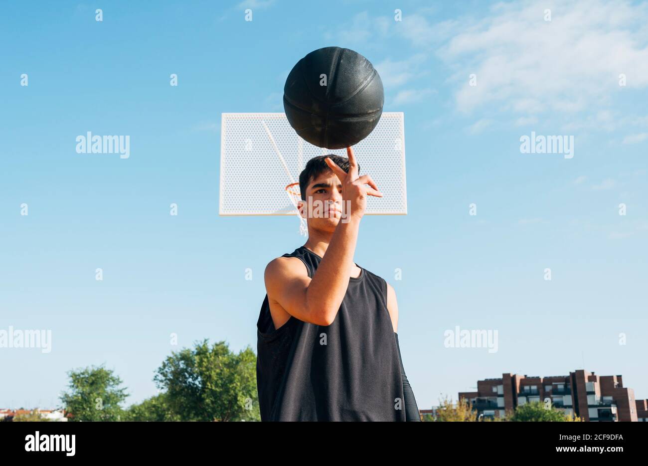 Young man playing on yellow basketball court outdoor Stock Photo - Alamy