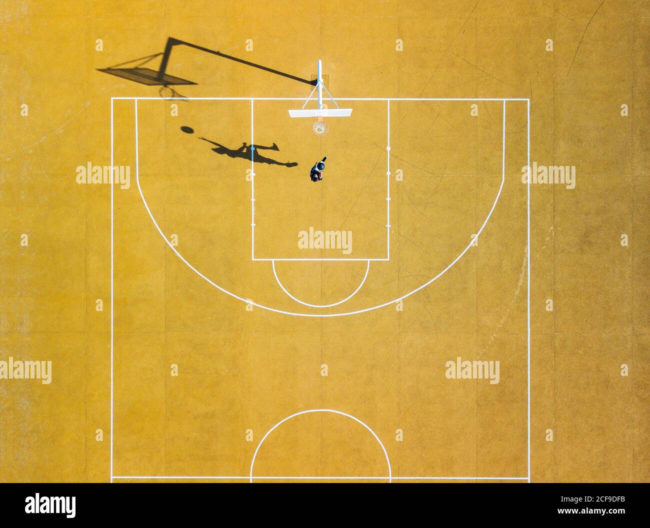 Young man playing basketball on outdoor court. Top view, bird eye view ...
