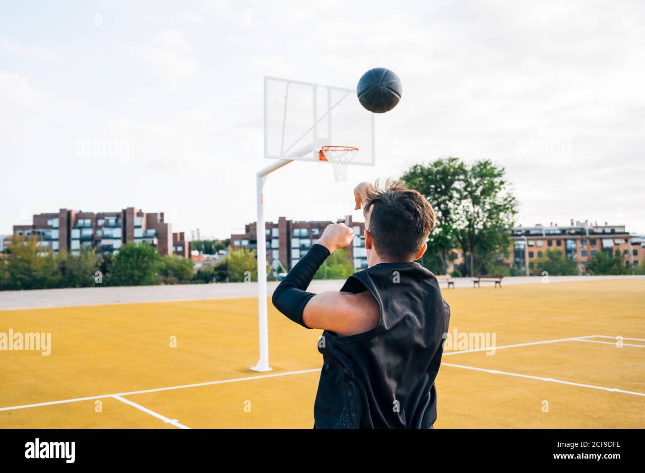 Young man playing on basketball court outdoor Stock Photo - Alamy