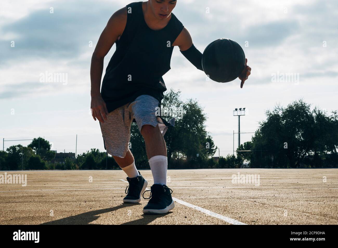 Young man playing on basketball court outdoor Stock Photo - Alamy