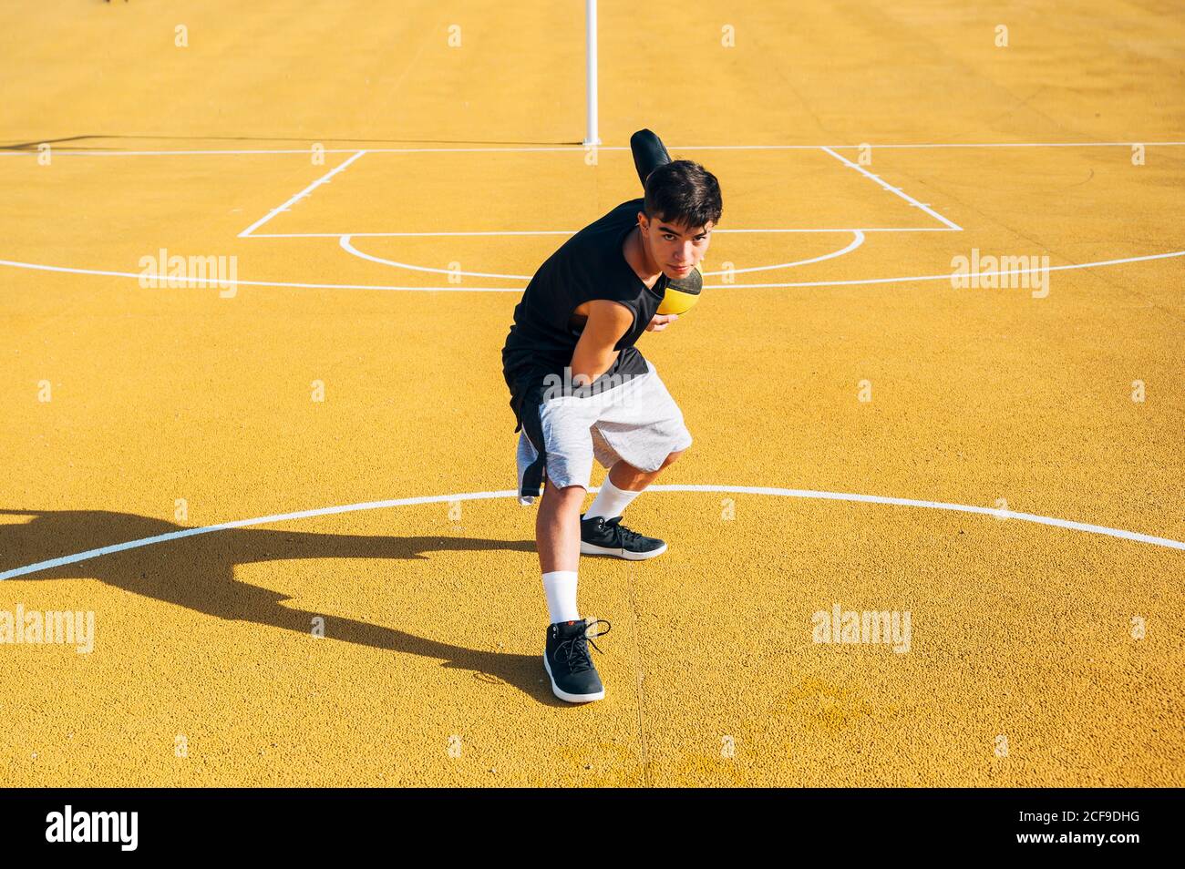 Young man playing on basketball court outdoor Stock Photo - Alamy