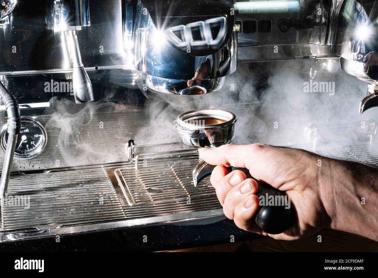anonymous barista preparing aromatic coffee while standing near ...