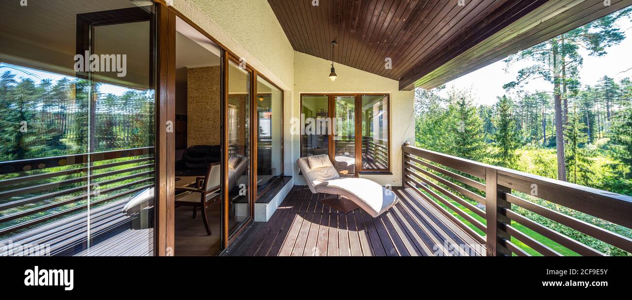 Panorama view of wooden terrace in luxury private house near green ...