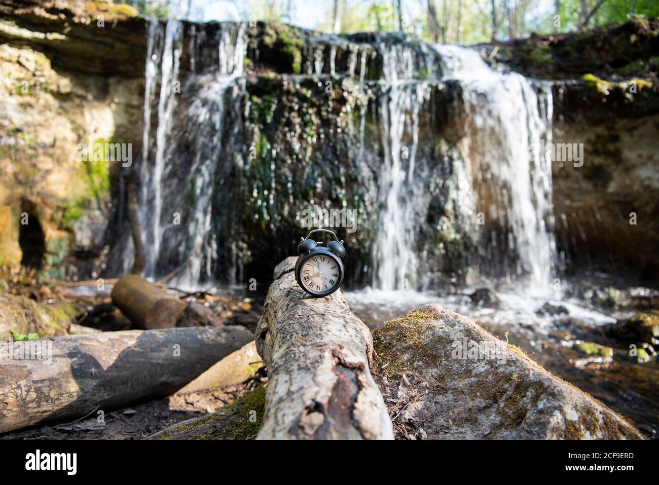 Retro alarm clock on waterfall background. Abstract photo of time Stock ...
