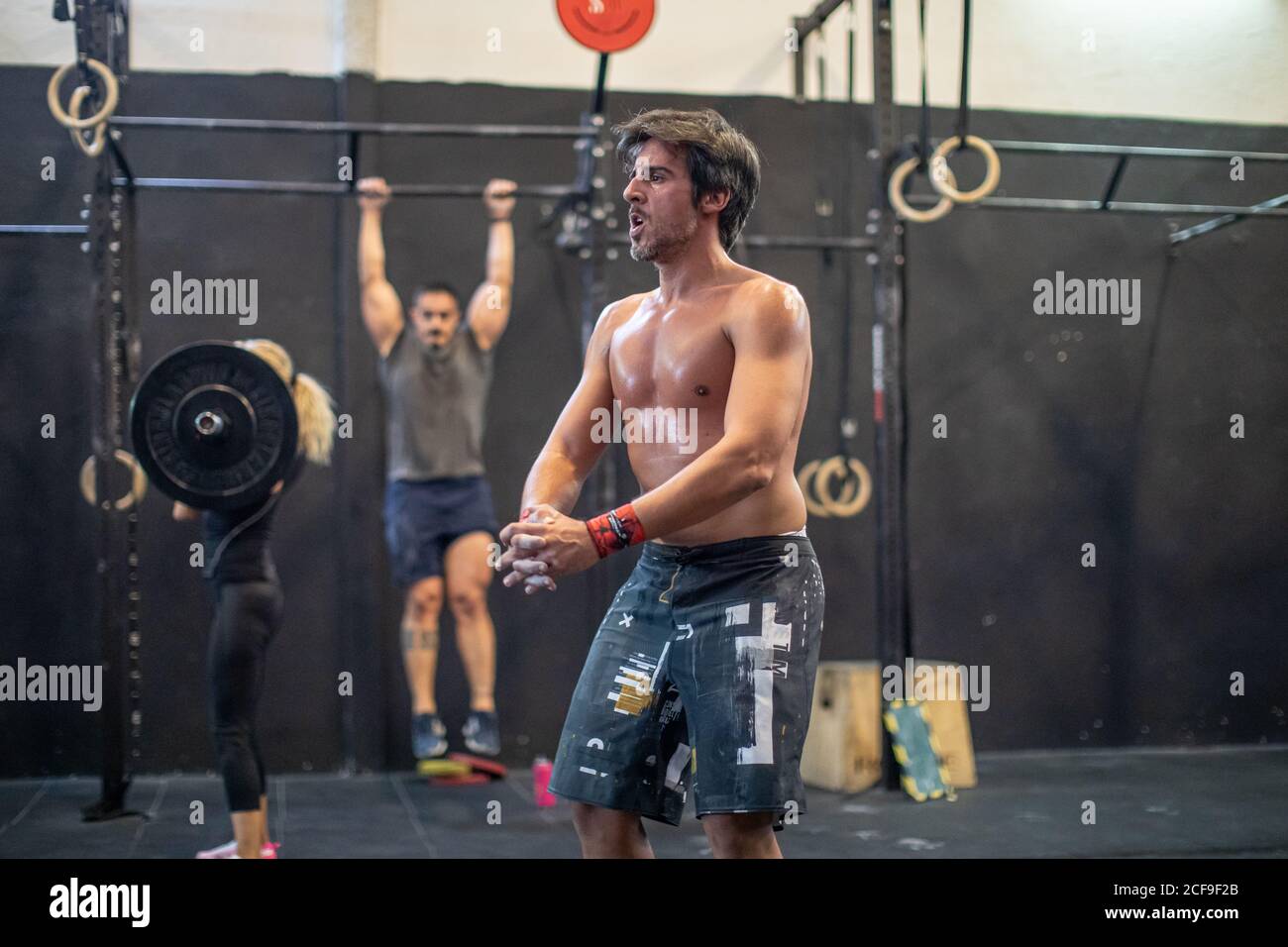 Tired man standing in gym Stock Photo - Alamy