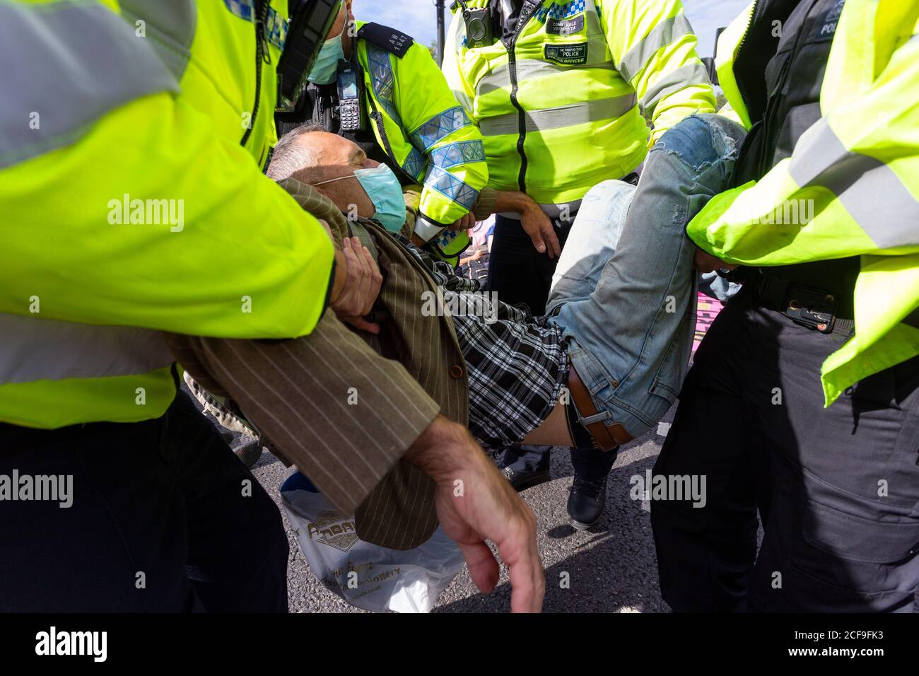 Police carry off an arrested protester, Extinction Rebellion ...