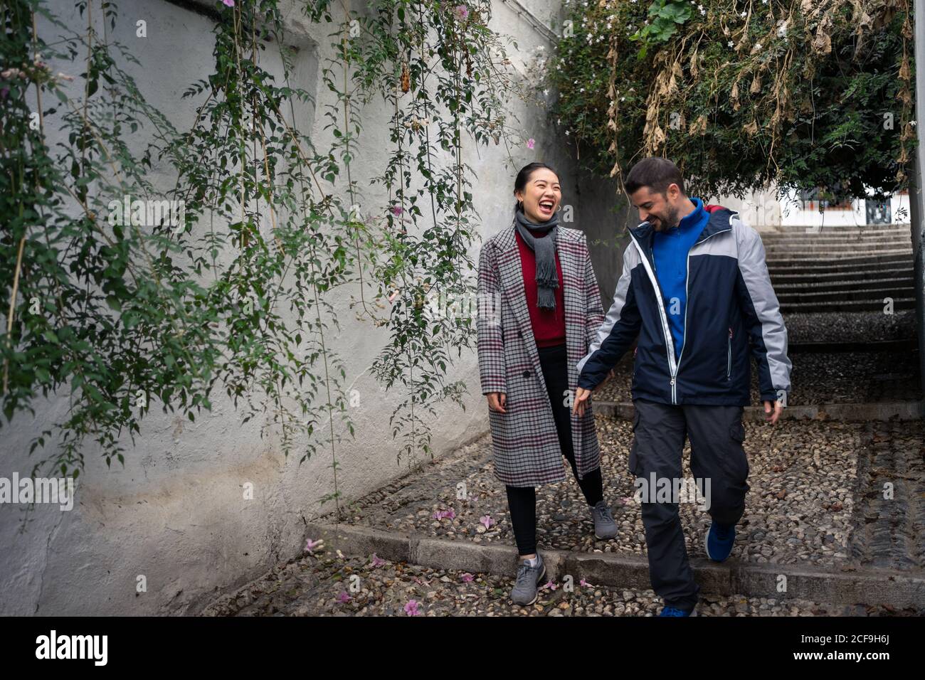 Pleased diverse couple exploring ancient town together Stock Photo - Alamy