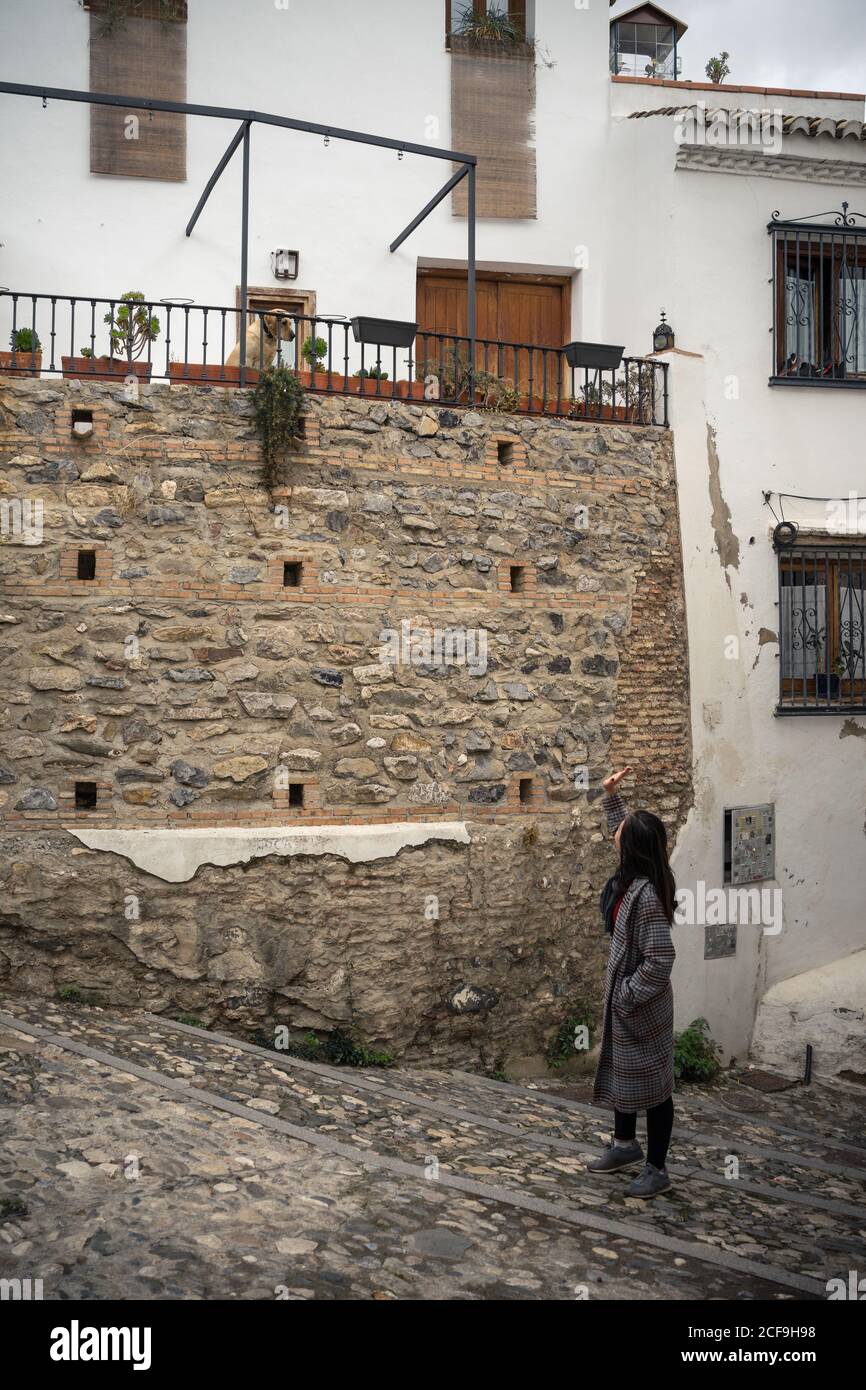 Asian female on aged cobblestone steps in city alley Stock Photo - Alamy