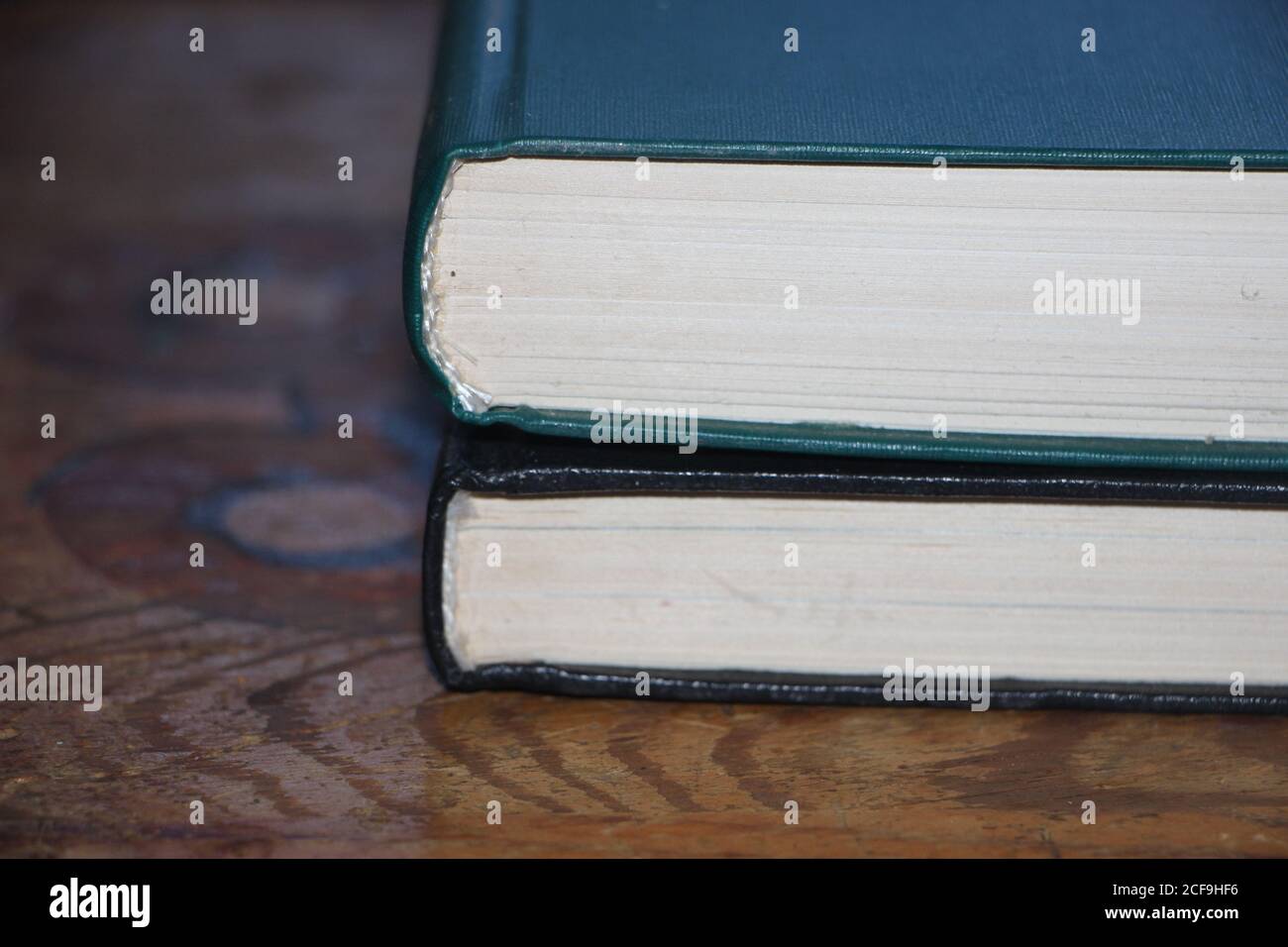 Two Books put togeter on old wooden table. Knowledge and education ...