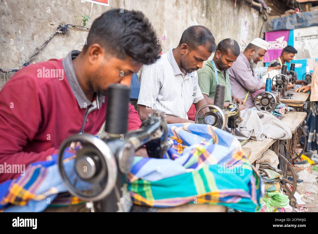Bangladesh - January, 25 2019: Group of ethnic men using sewing ...