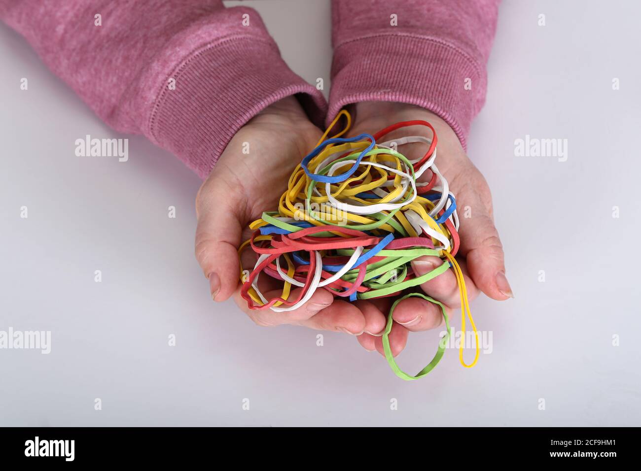 Rubber bands in hands Stock Photo - Alamy