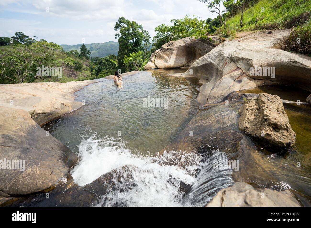 Slim Woman swimming in natural pool in mountain waterfall Stock Photo ...