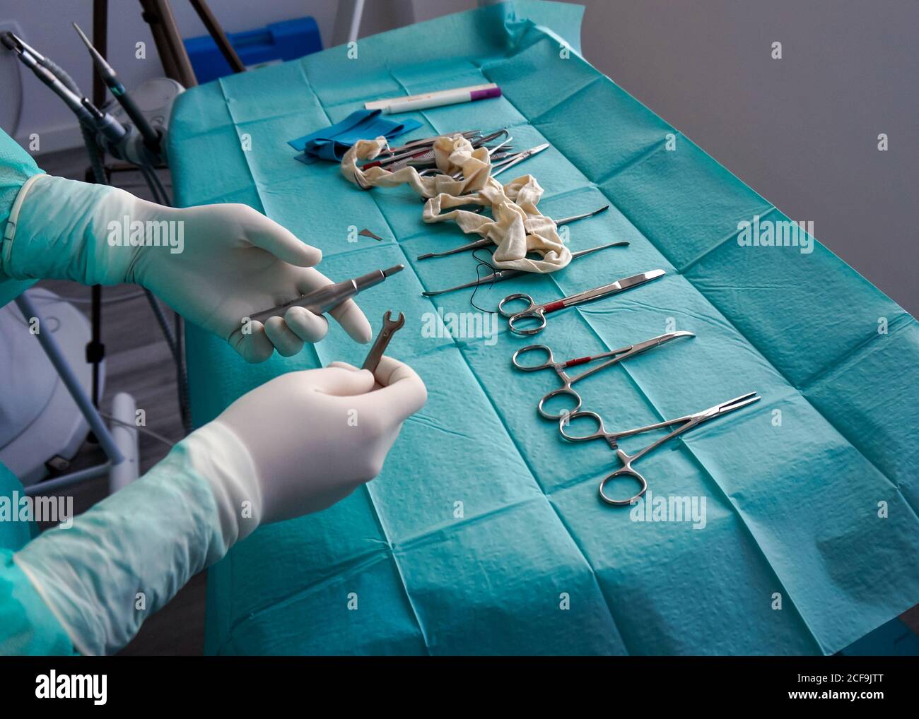 From above of faceless nurse in rubber gloves choosing tools for ...