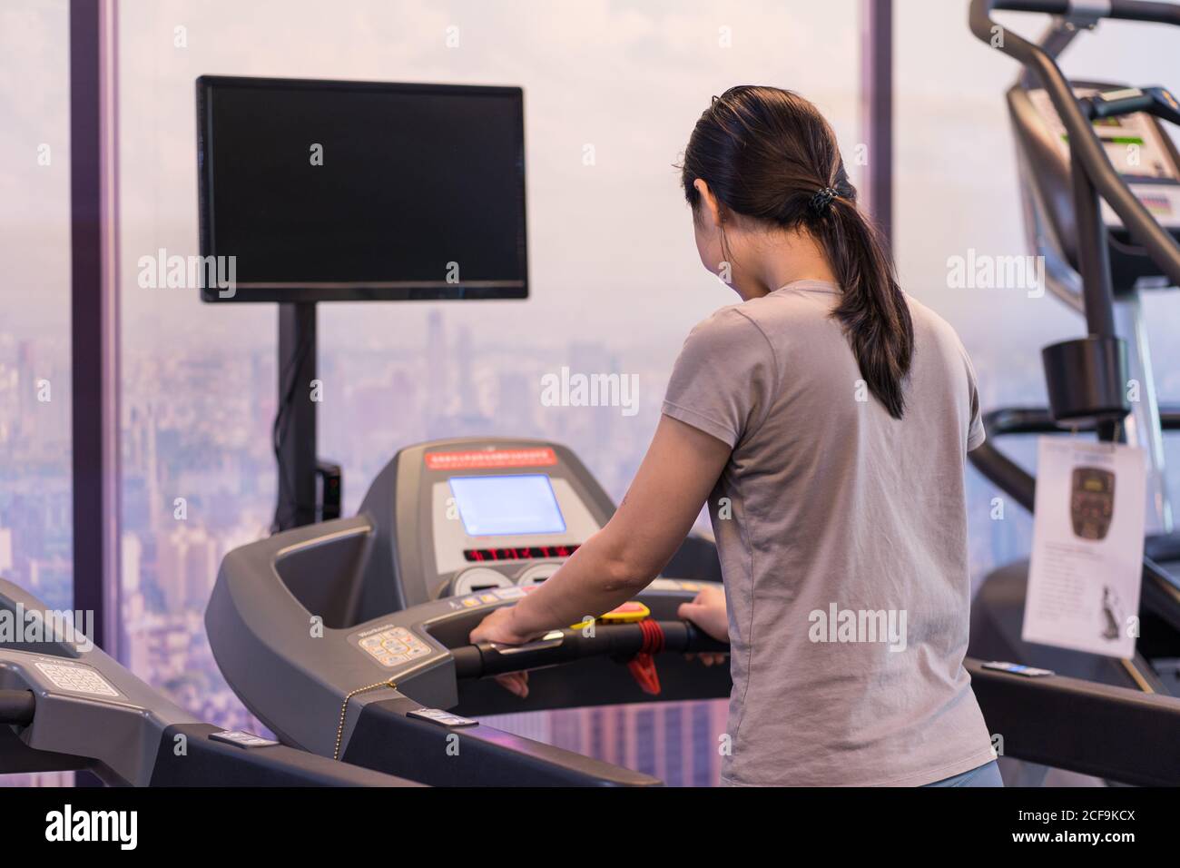 Back view of unrecognizable female athlete in sportswear running on ...