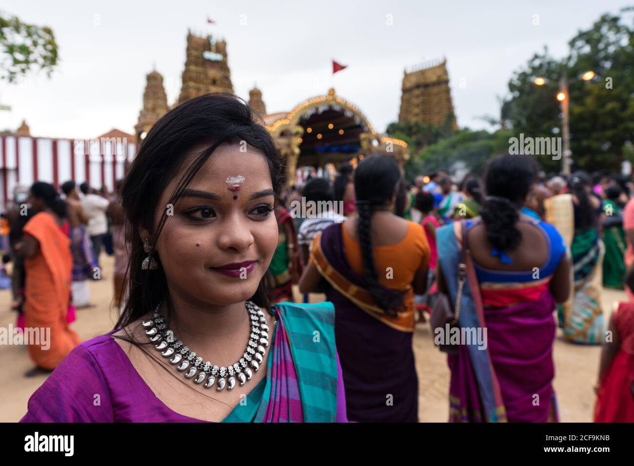 Jaffna, Sri Lanka - August, 9 2019: Young Tamil female in colorful traditional clothes looking ...