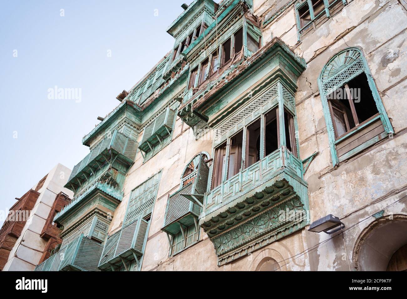 Low angle of aged stone buildings with shabby walls and balconies on ...