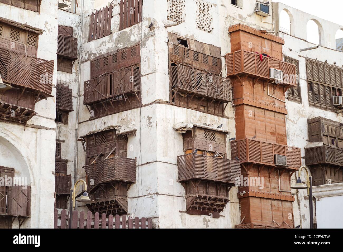 Low angle of aged stone buildings with shabby walls and balconies on ...