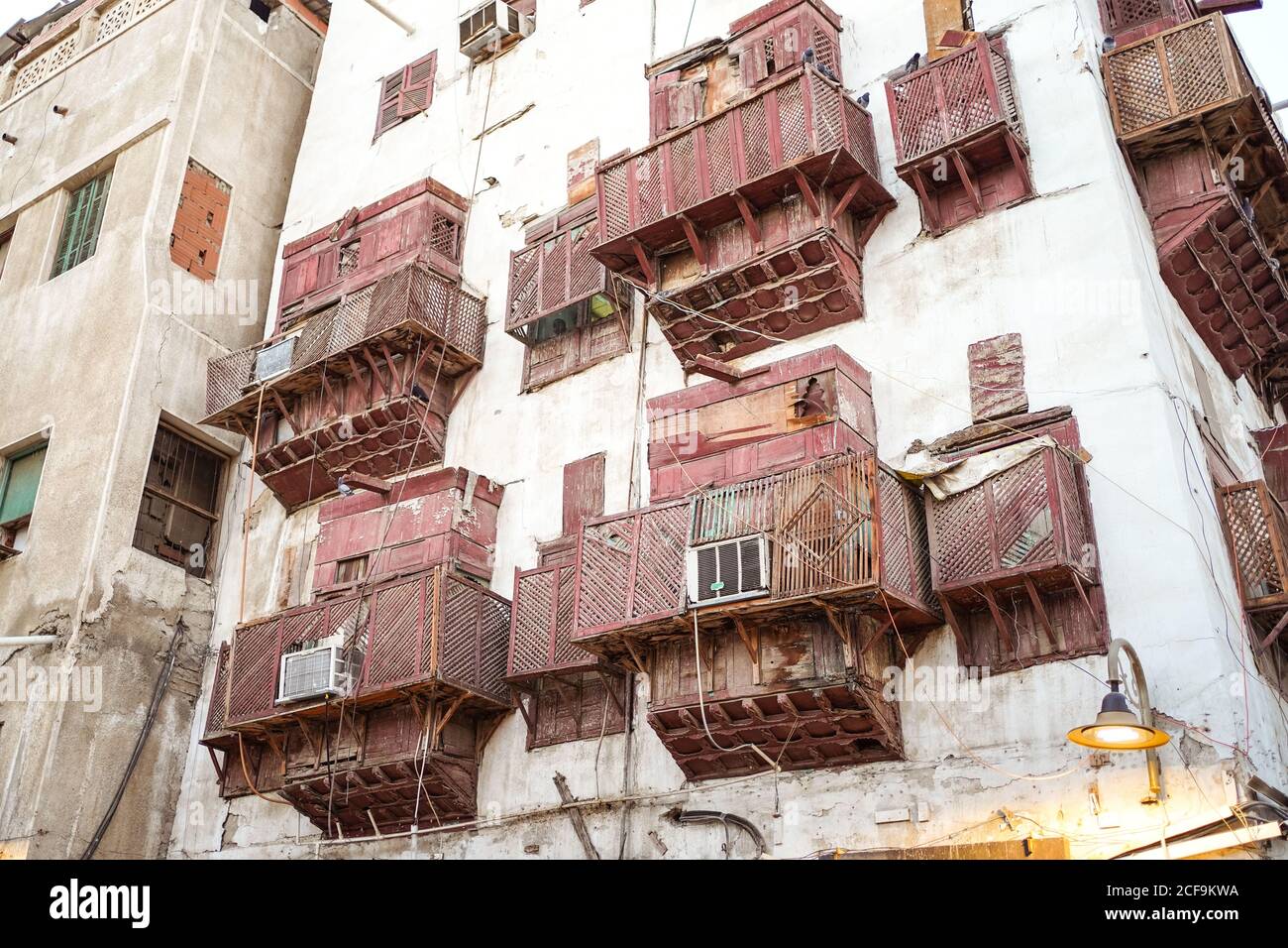 Low angle of aged stone buildings with shabby walls and balconies on ...