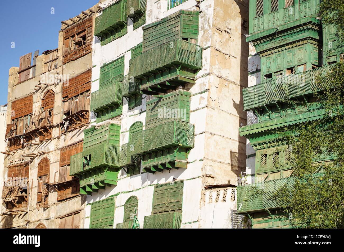Low angle of aged stone buildings with shabby walls and balconies on ...