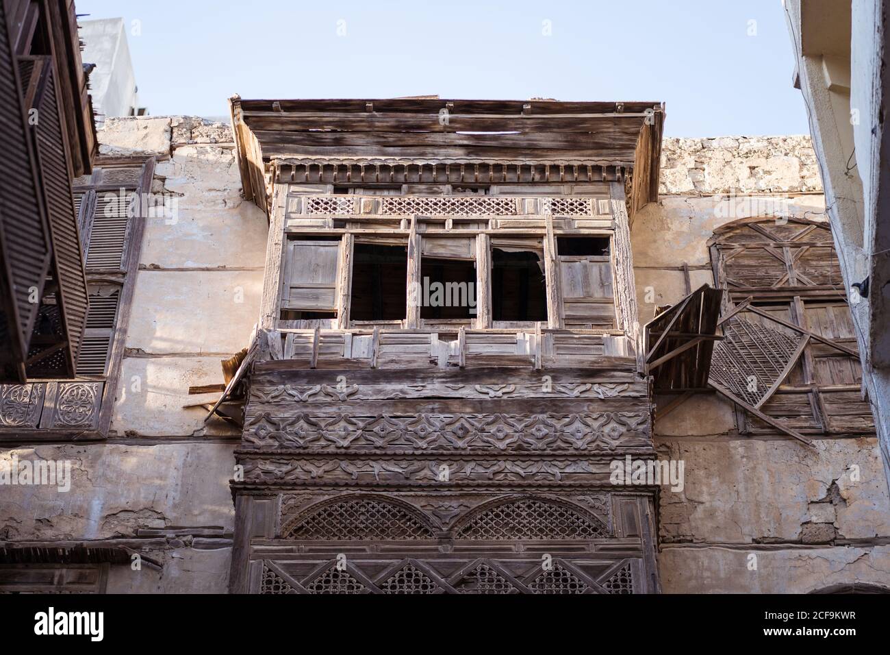 Low angle of aged stone buildings with shabby walls and balconies on ...
