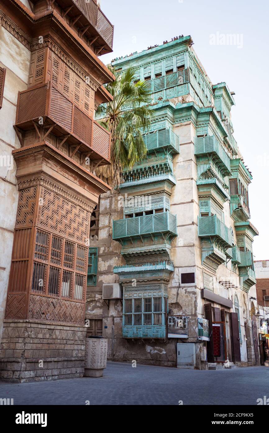 Low angle of aged stone buildings with shabby walls and balconies on ...