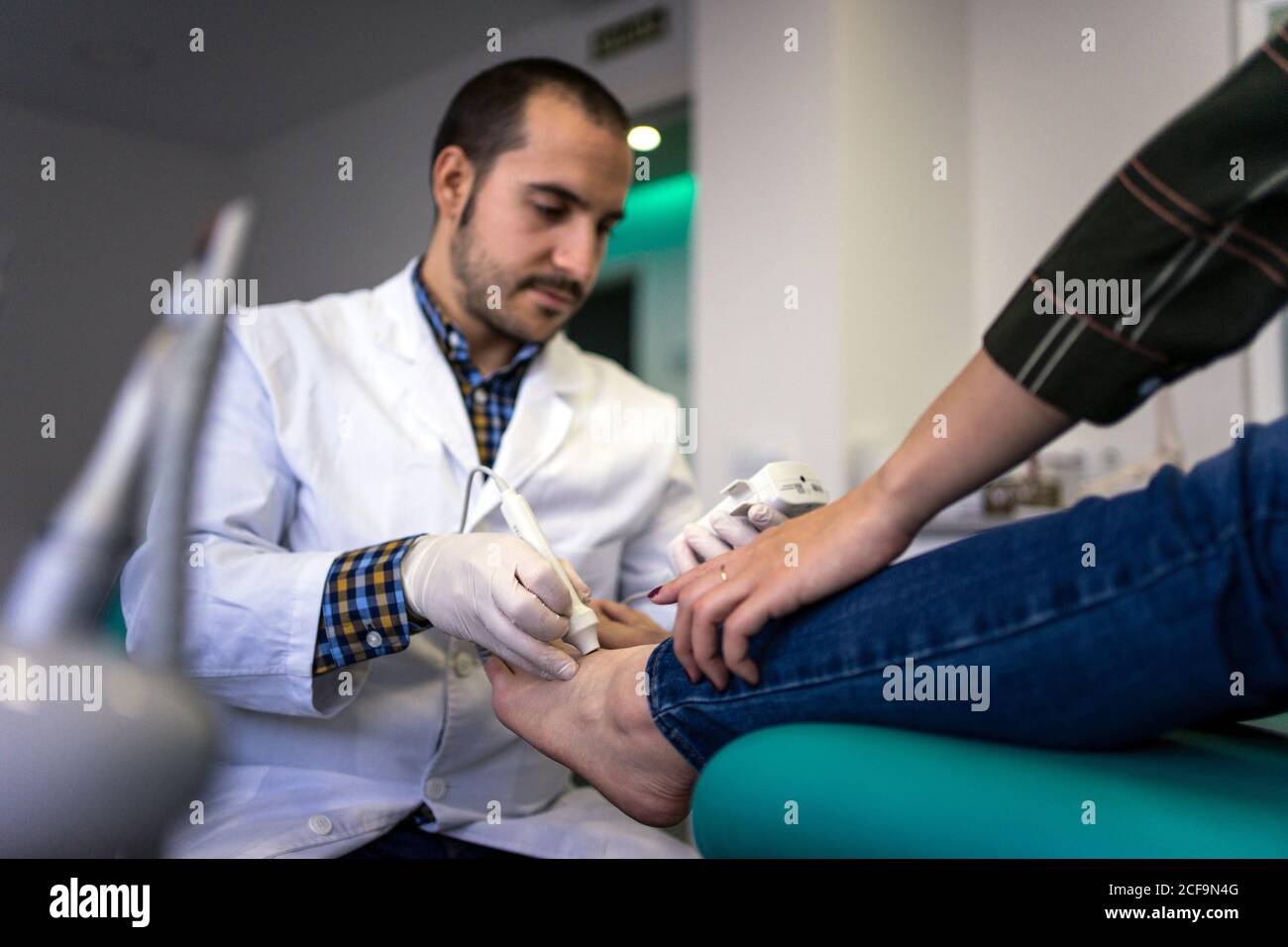 Podiatrist examining foot patient hi-res stock photography and images ...