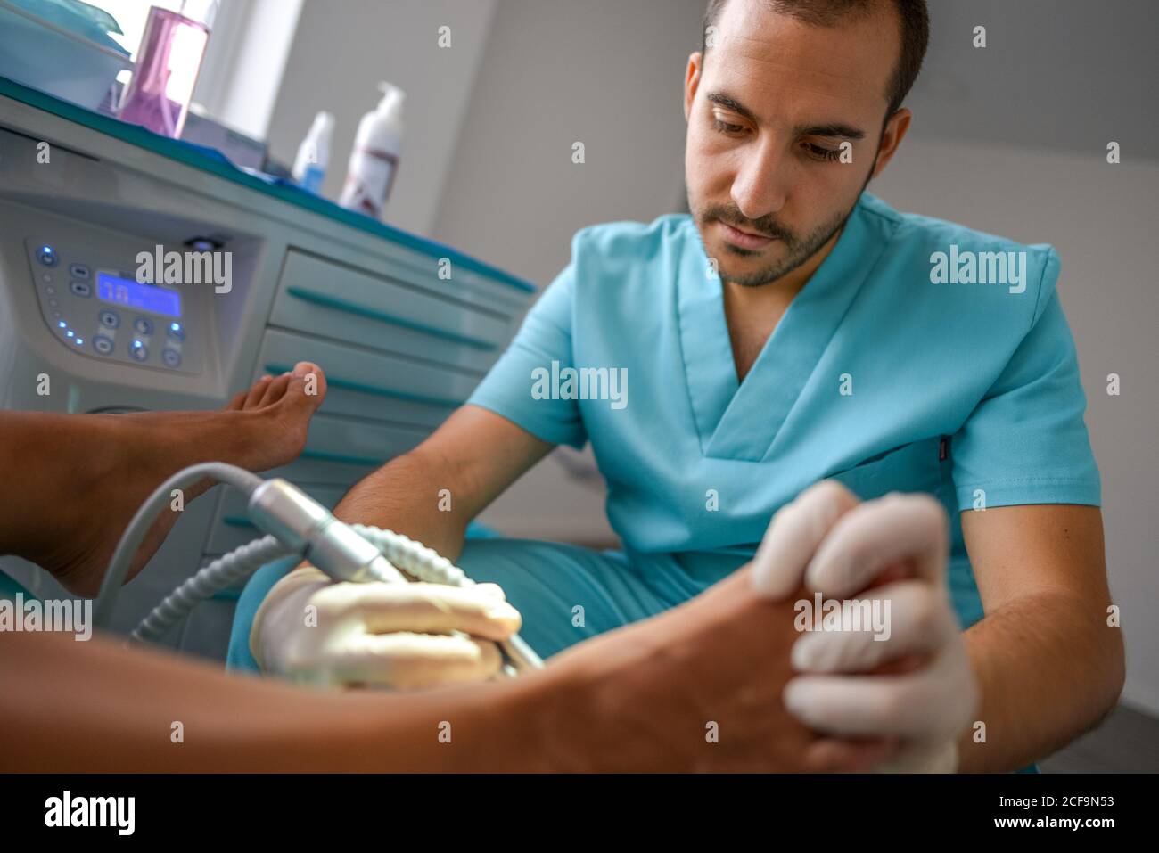 Podiatrist making procedure with patient Stock Photo - Alamy