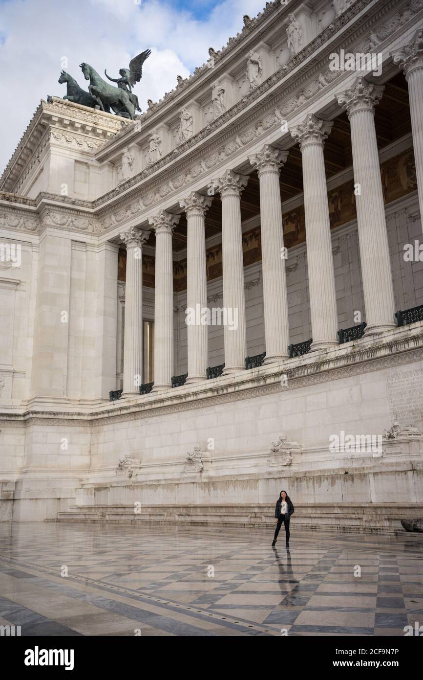 Female traveler standing outside ancient building colonnade trip to ...