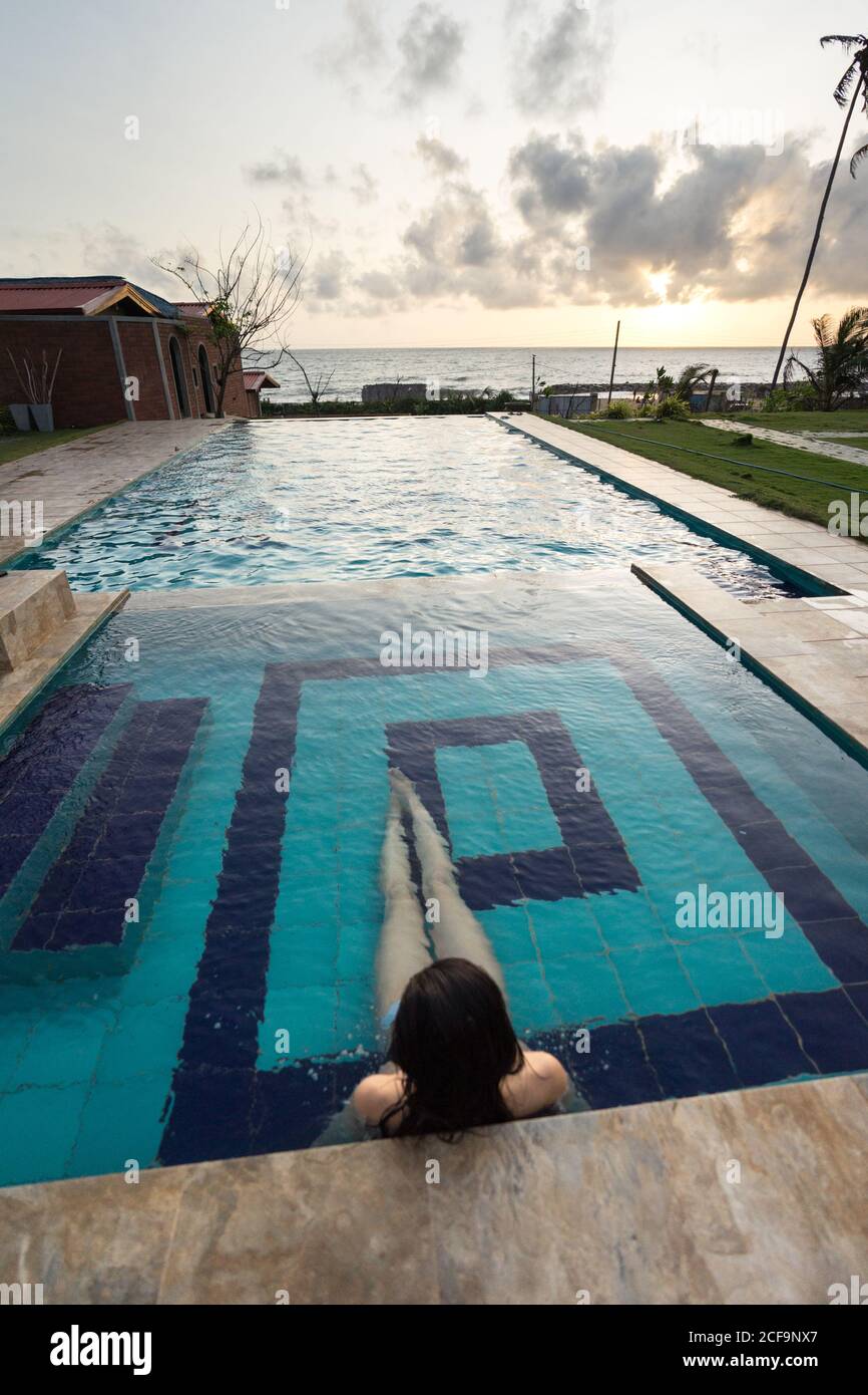 anonymous female traveler in swimsuit resting in pool at resort Stock ...