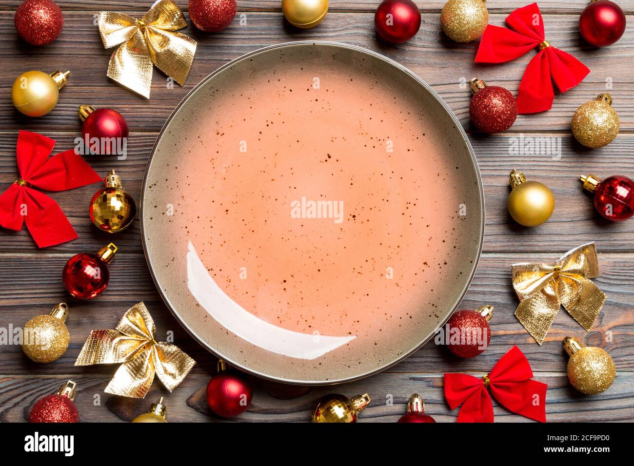 Top view of holiday dinner on wooden background. Plate, baubles and ...