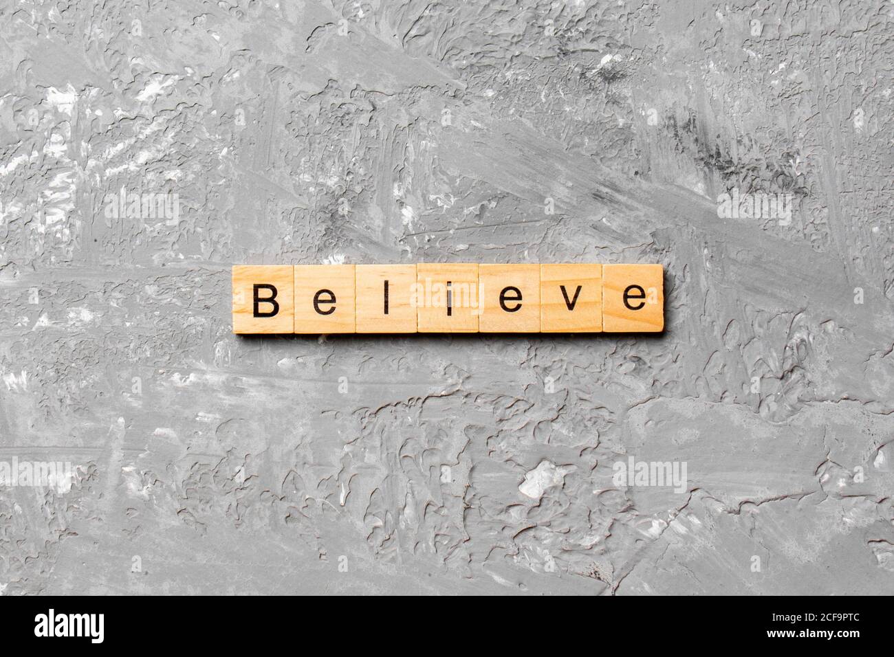 believe word written on wood block. believe text on table, concept ...