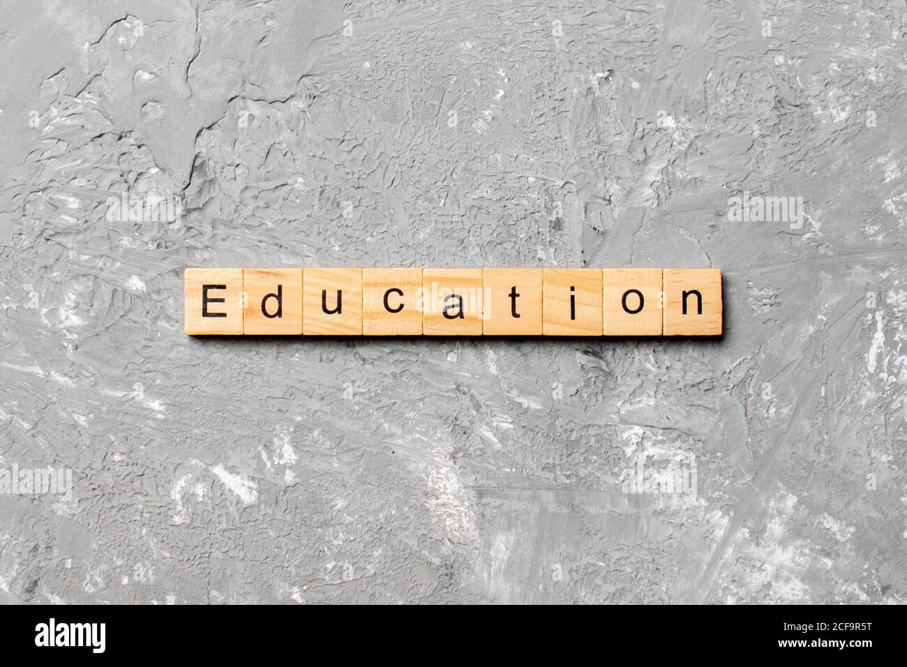 Education word written on wood block. Education text on cement table ...