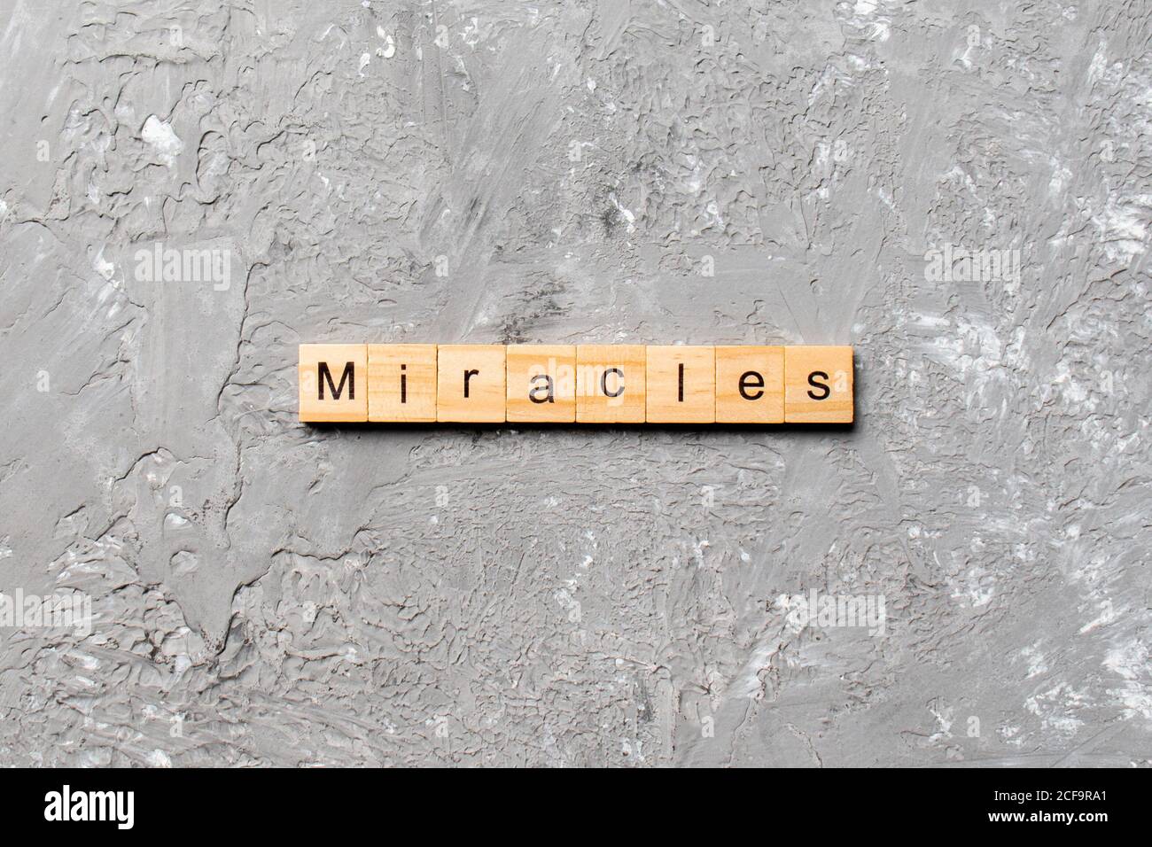 The miracles word written on wood block. miracles text on cement table ...