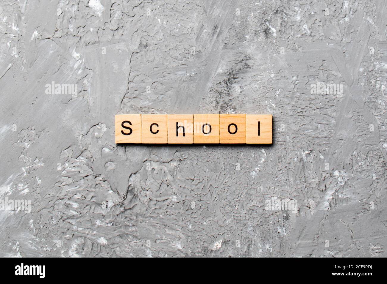 school word written on wood block. school text on cement table for your ...