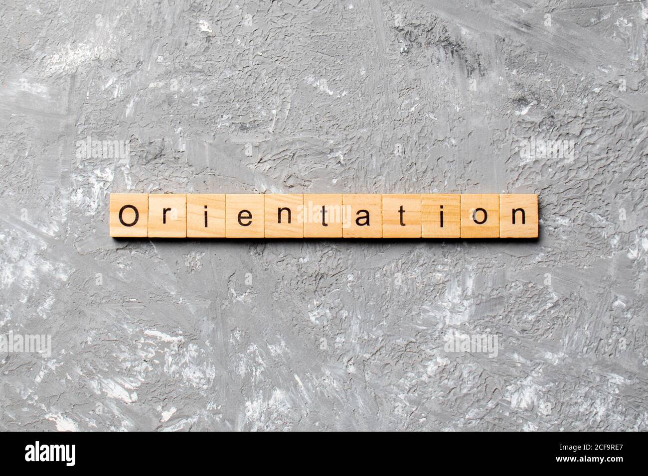 Orientation word written on wood block. Orientation text on cement ...