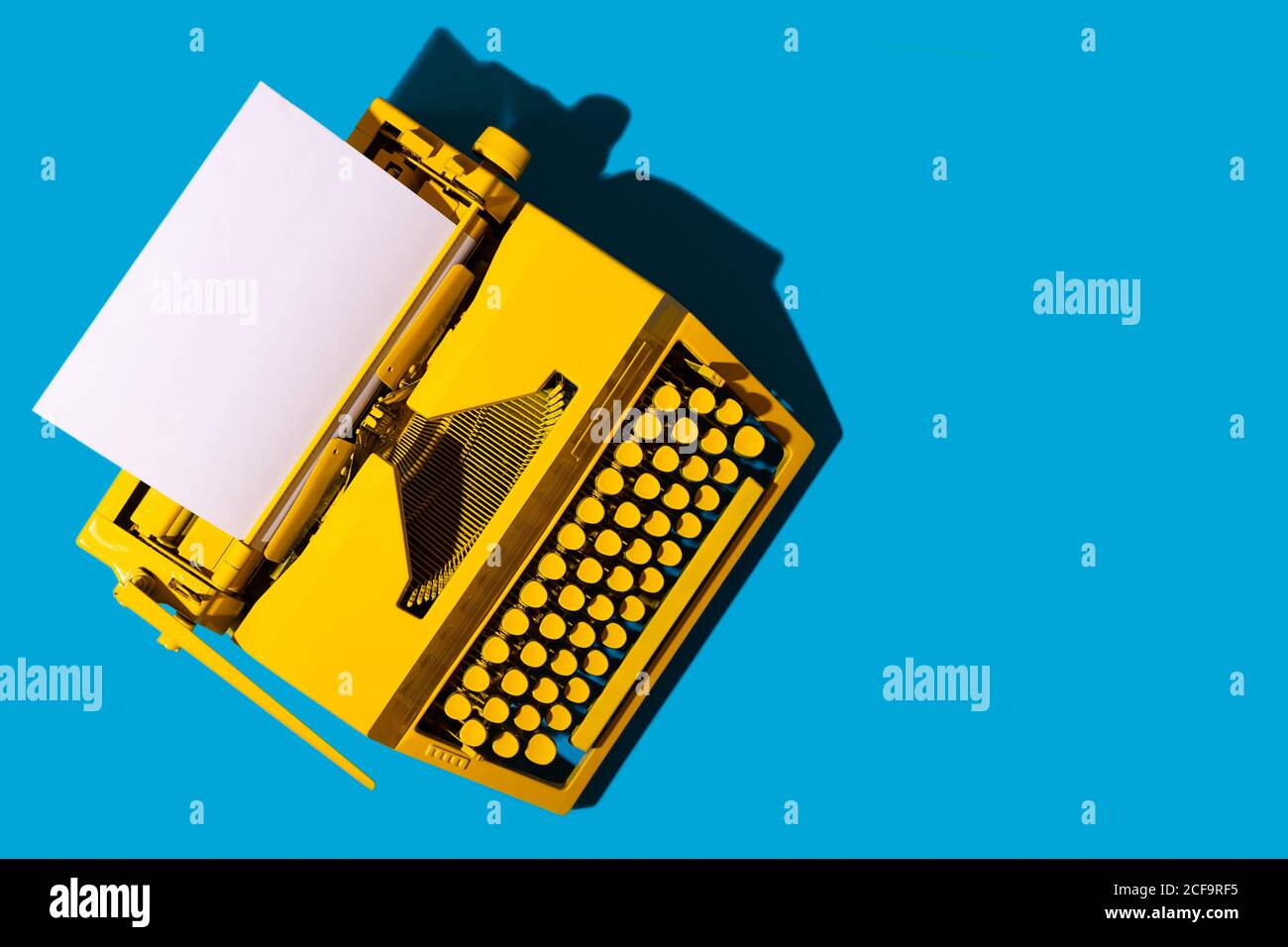 Yellow bright typewriter on blue background. Creativity concept Stock ...