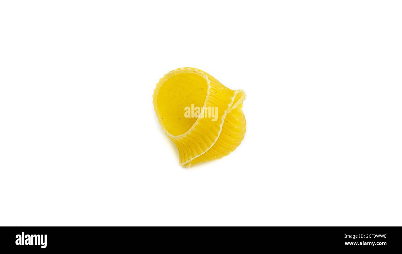Raw pasta lumaconi rigati, macro isolated on white background Stock ...