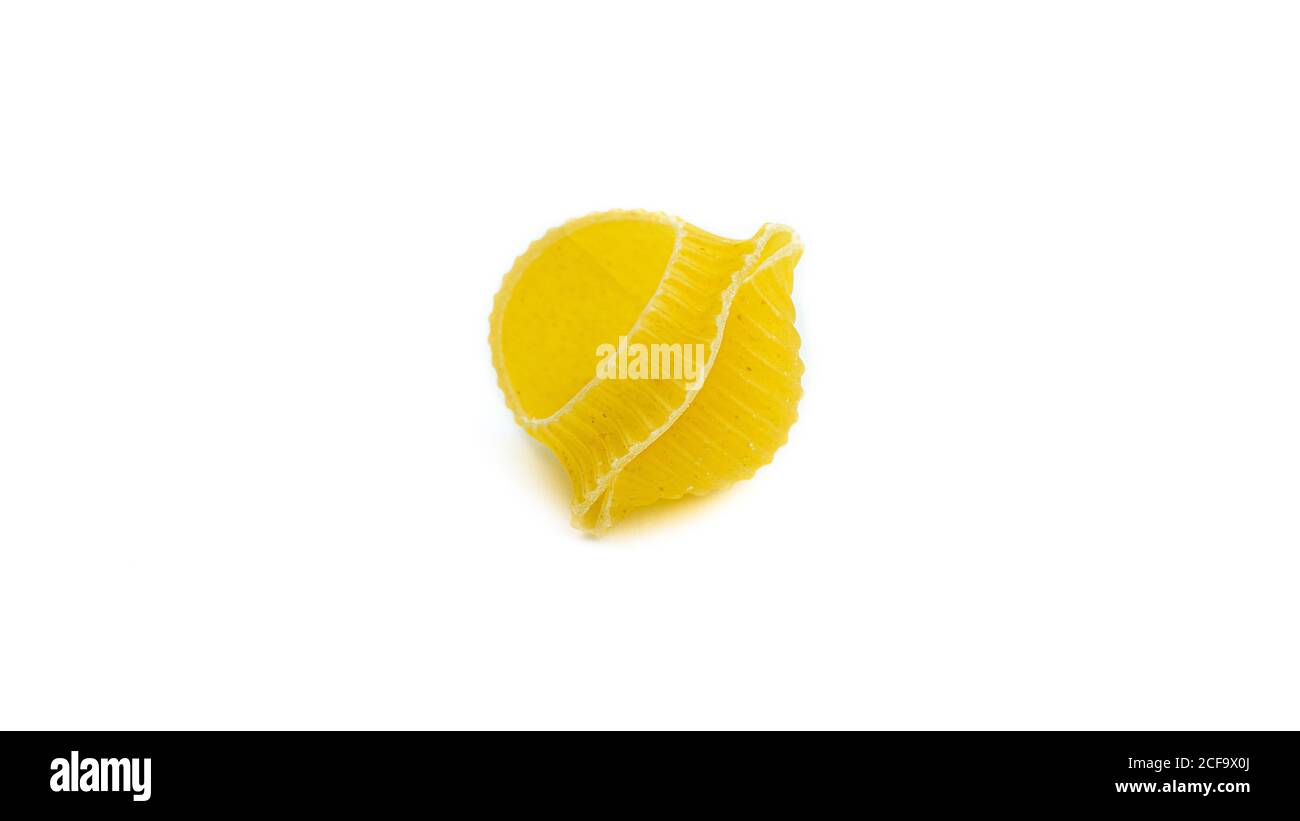 Raw pasta lumaconi rigati, macro isolated on white background Stock ...