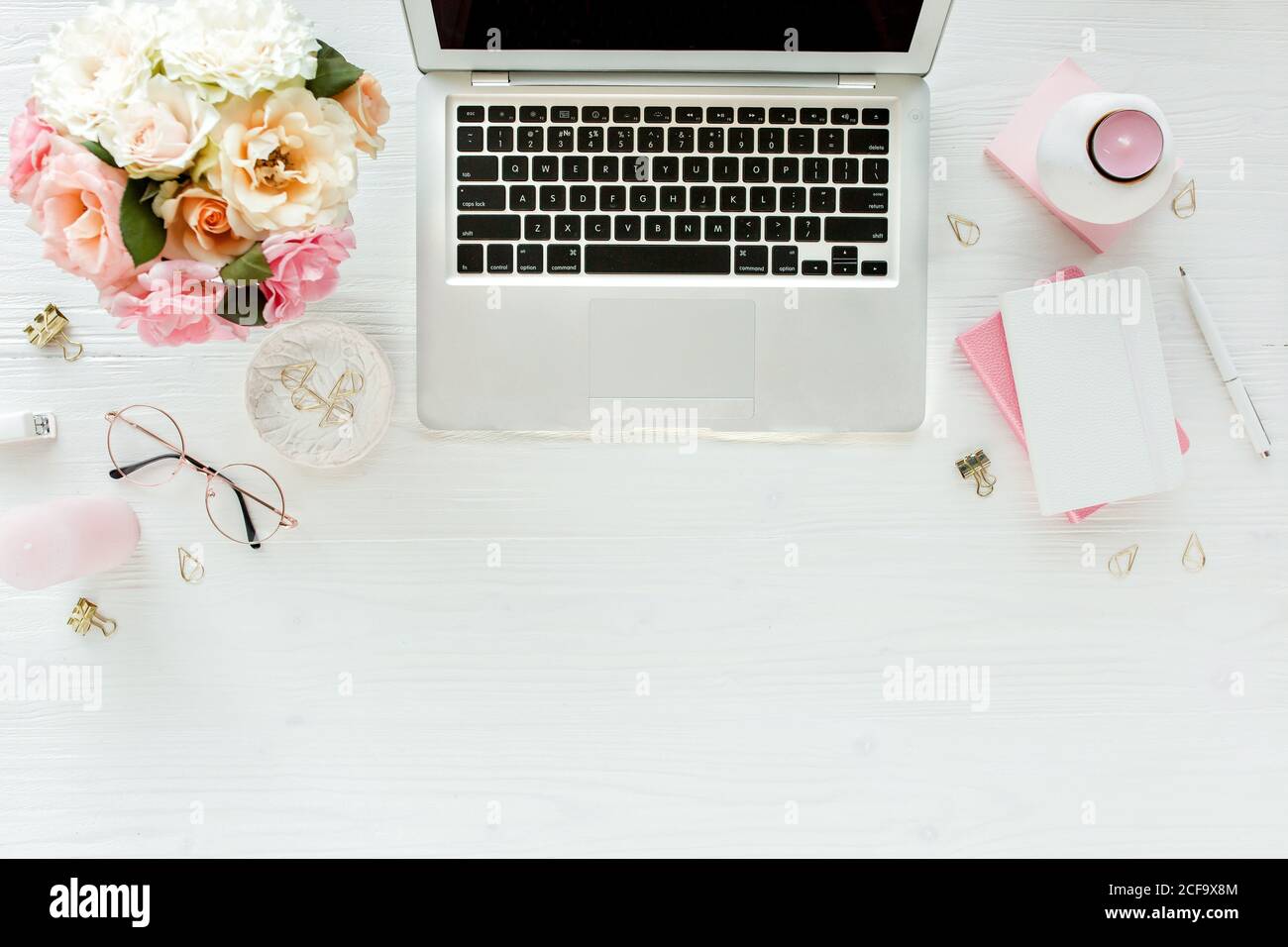 Flat lay women's office desk. Female workspace with laptop, pink roses ...