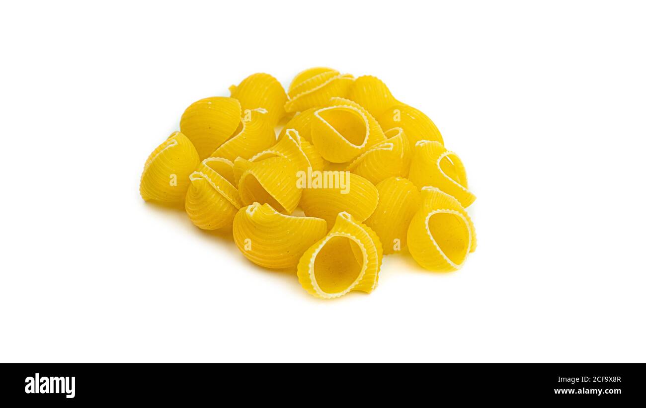 Raw pasta lumaconi rigati, macro isolated on white background Stock ...
