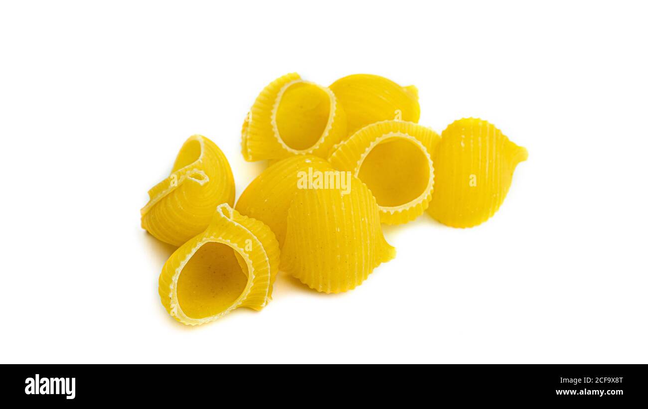 Raw pasta lumaconi rigati, macro isolated on white background Stock ...