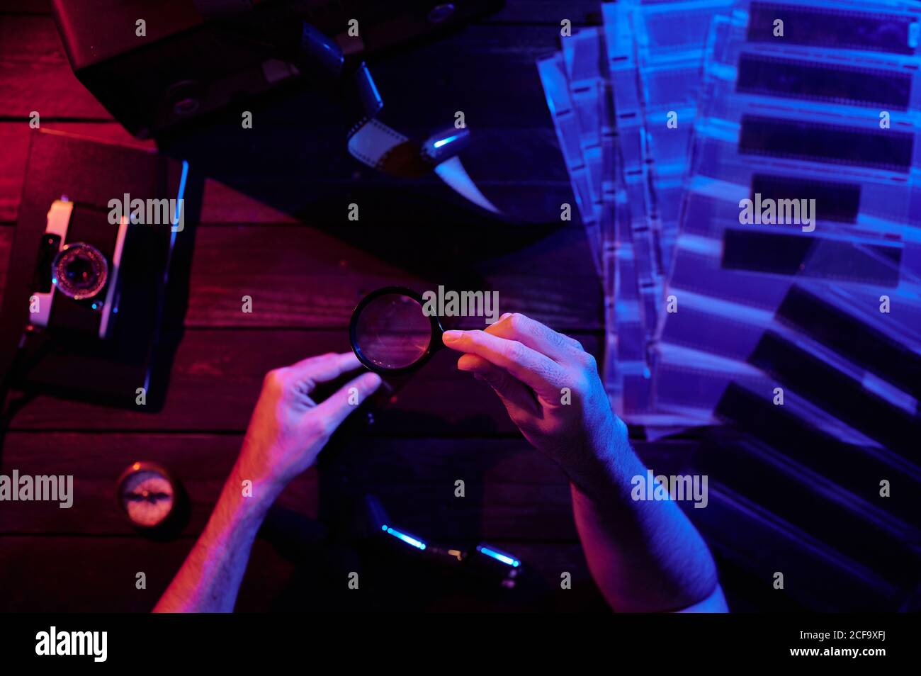 From above view of crop unrecognizable photographer holding vintage ...