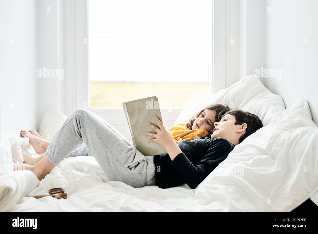 Brother sister lying on bed hi-res stock photography and images - Alamy