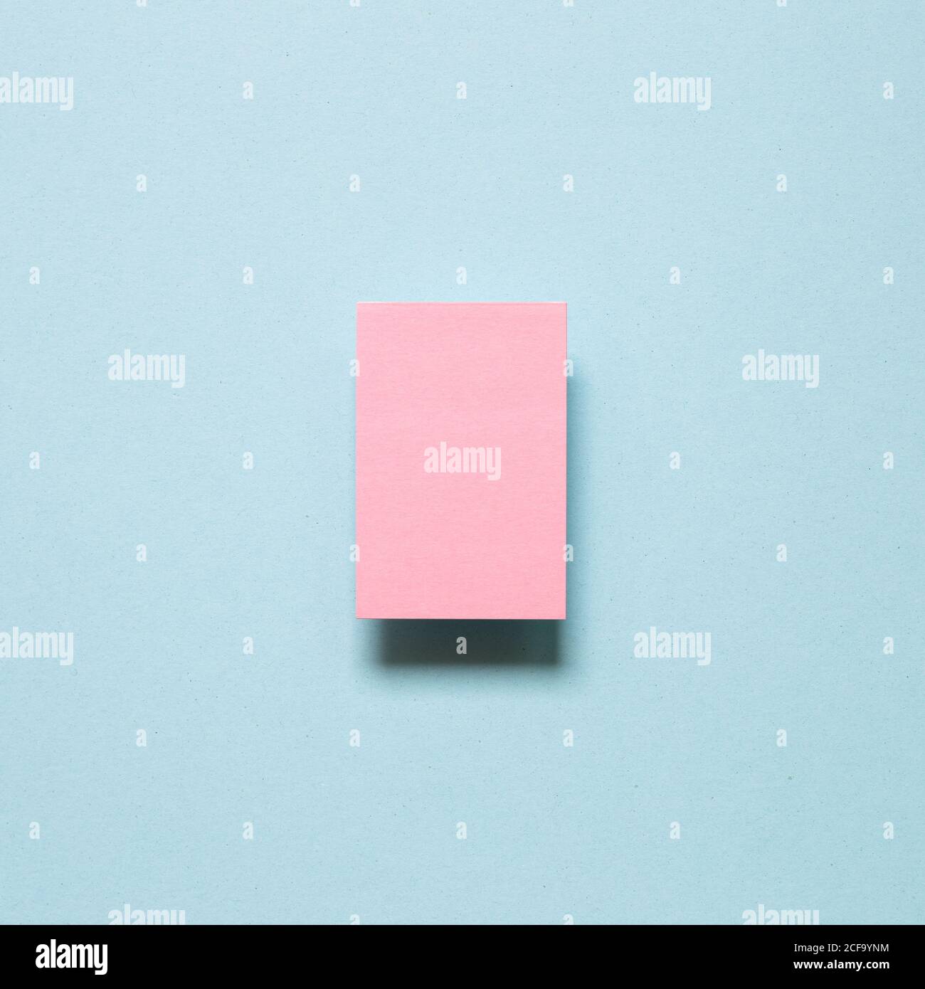Pink memo paper, sticky notes on blue background. top view, copy space ...