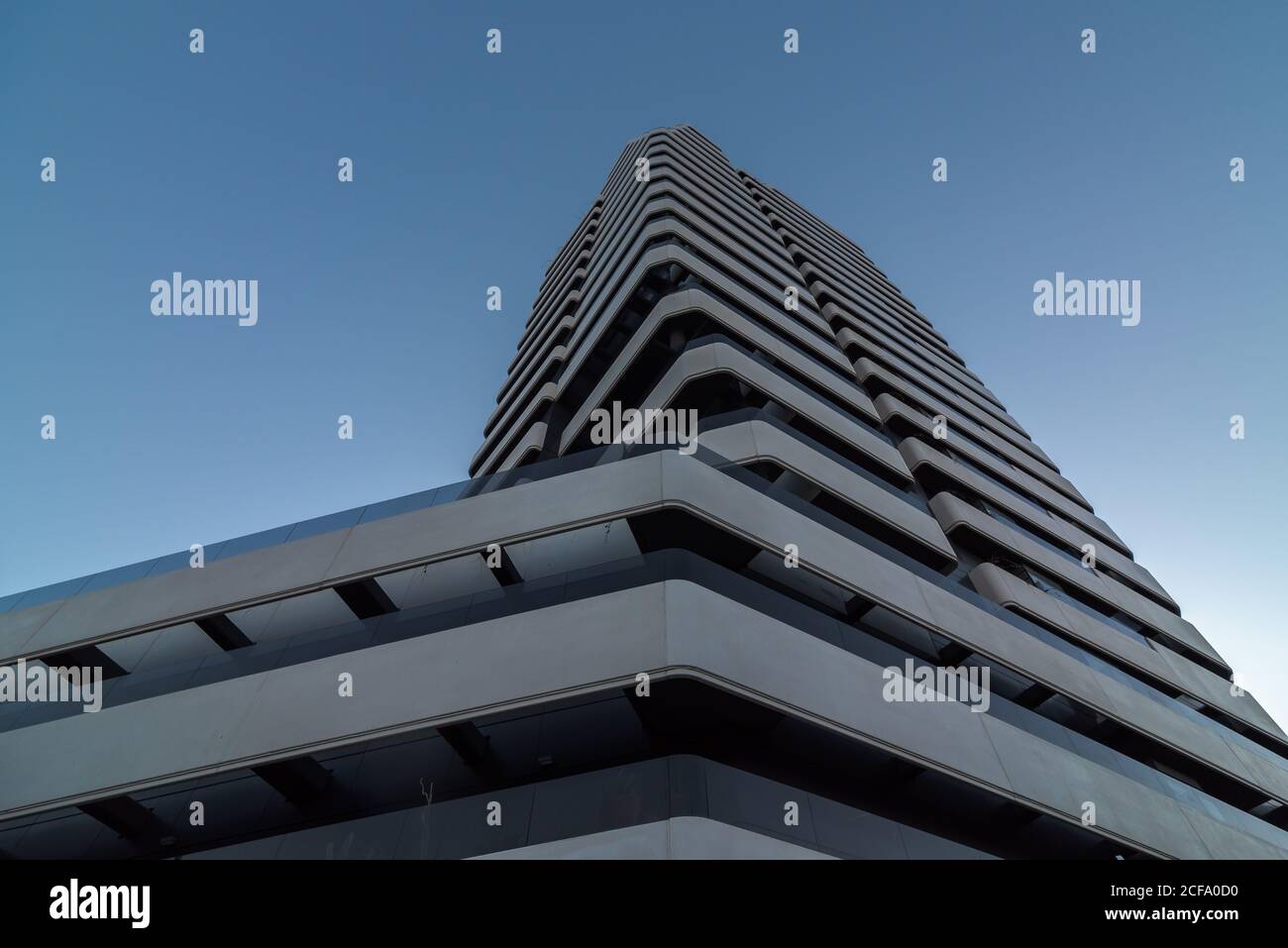 From below of modern high concrete building facade with rows of ...