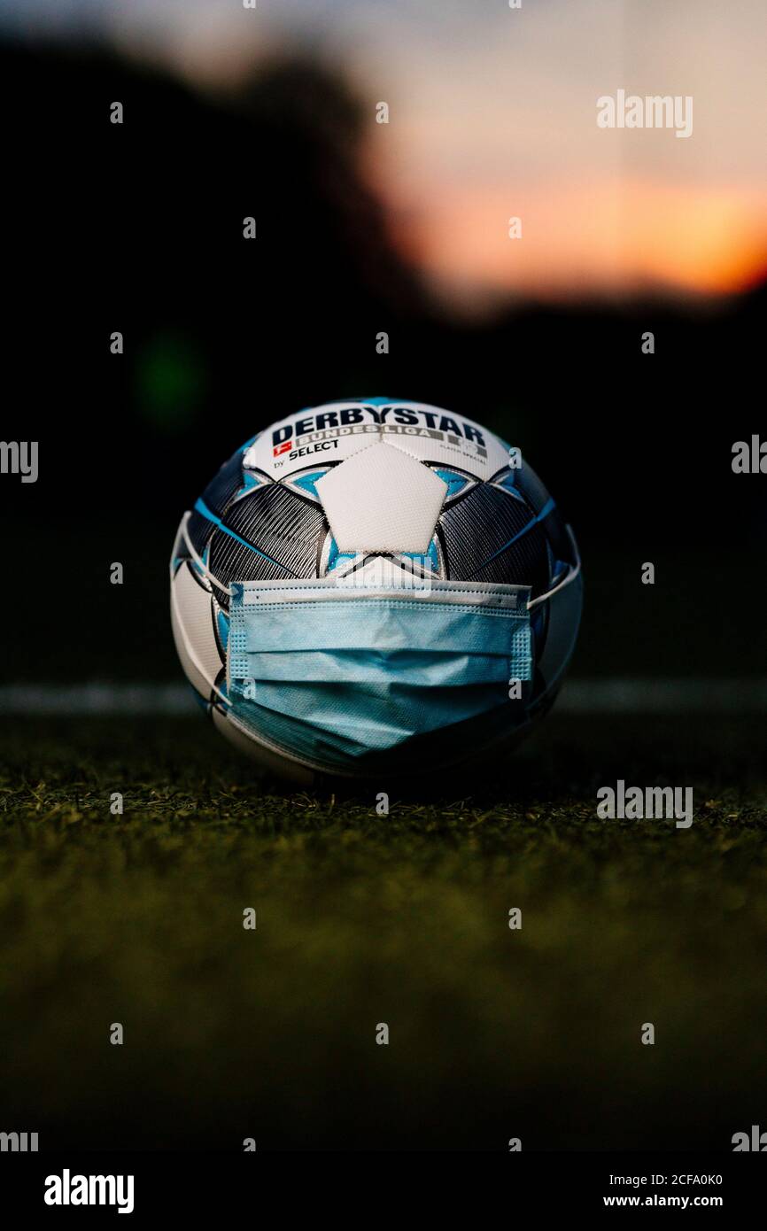 The official match ball of the Bundesliga Derbystar lies with a face ...