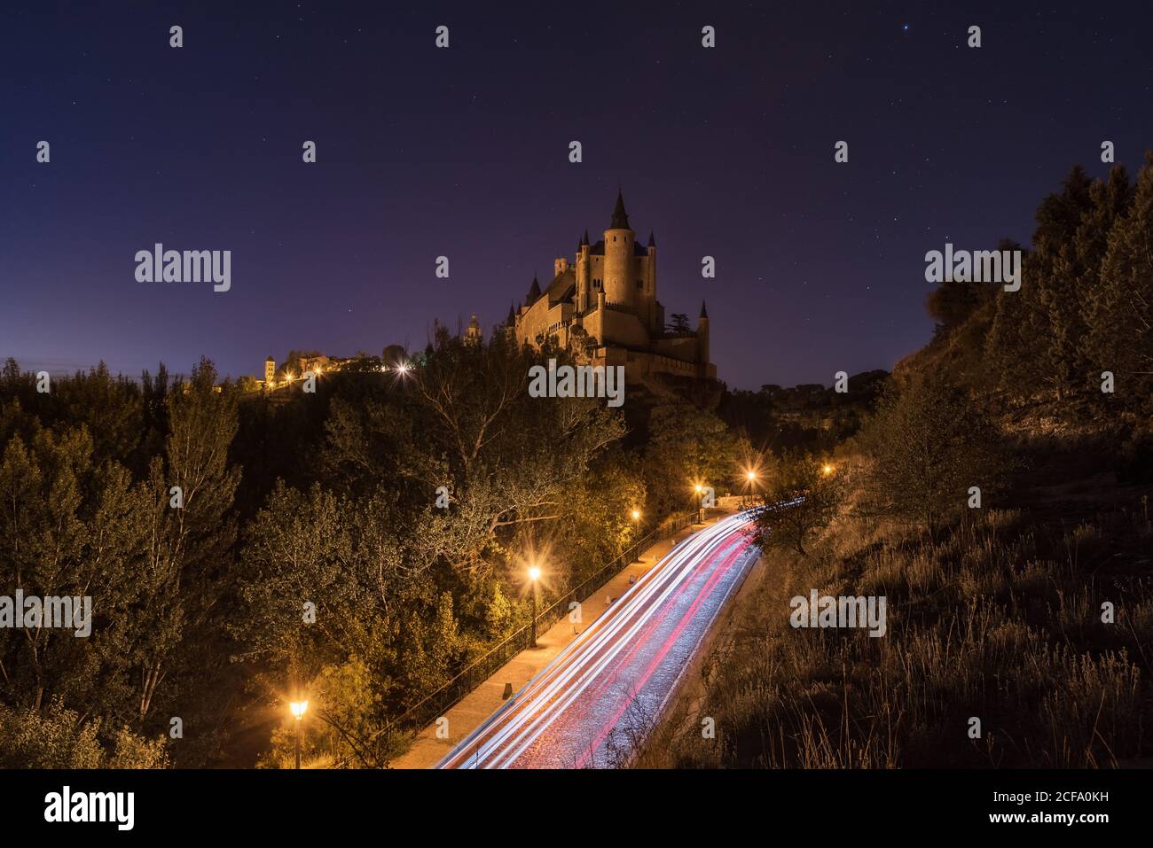 From above of ancient fortress surrounded by trees and luminous highway ...
