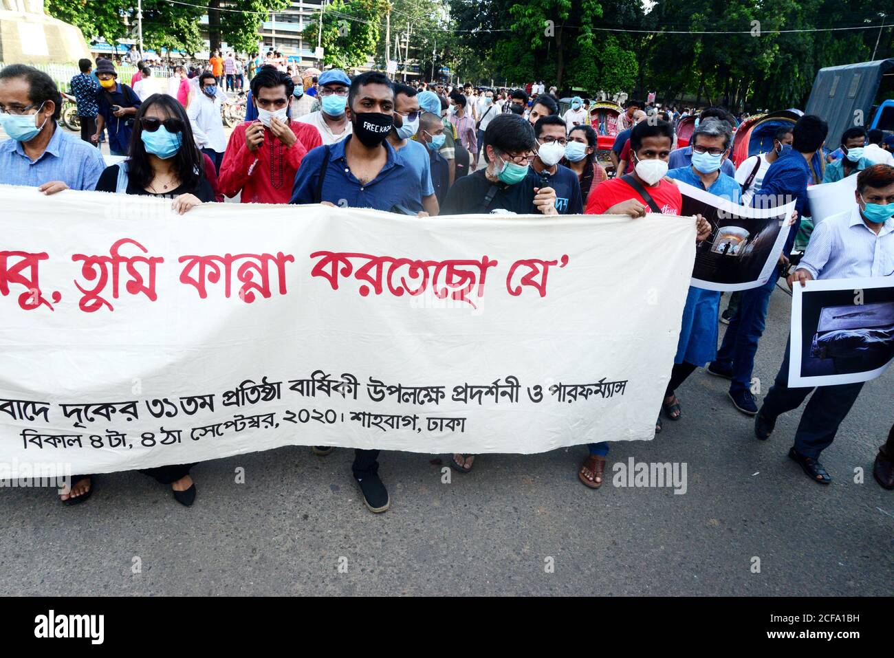 Activist holds banner as they march during the exhibition and ...