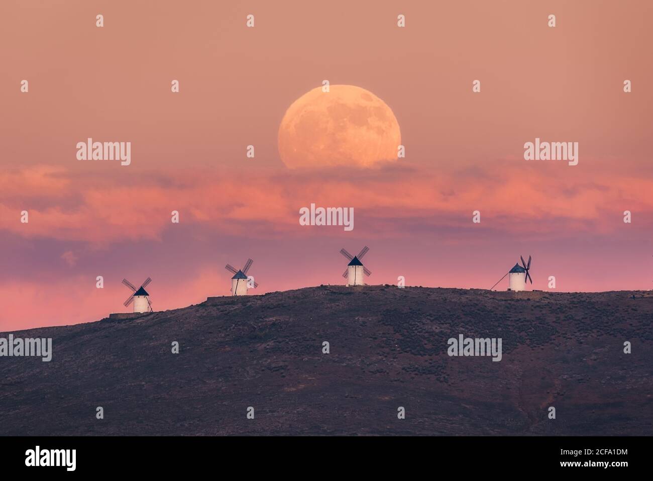 Amazing scenery of majestic full Moon over valley with windmills in ...